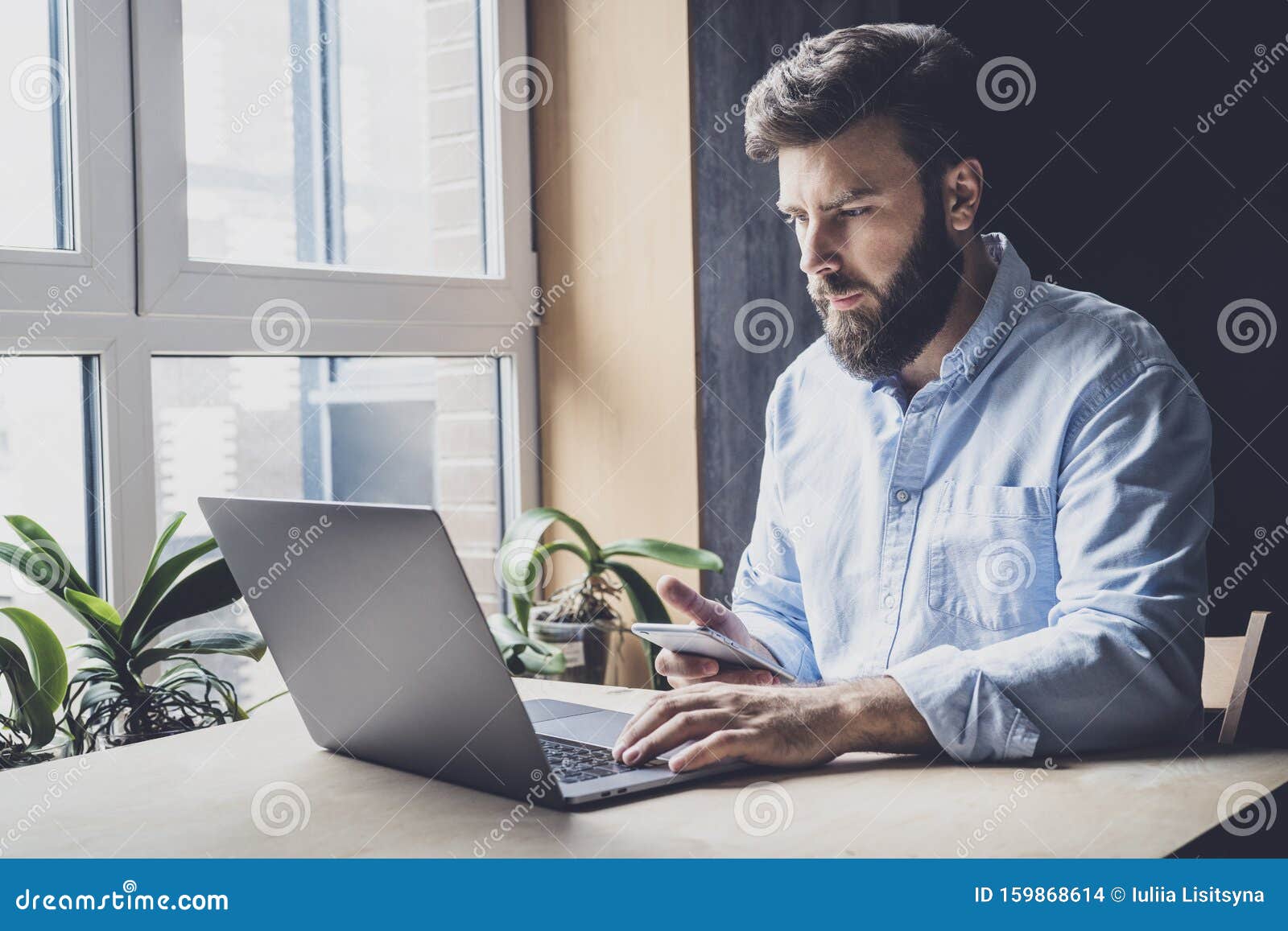 Man Working in Office Using Wireless Digital Gadgets for Projects ...