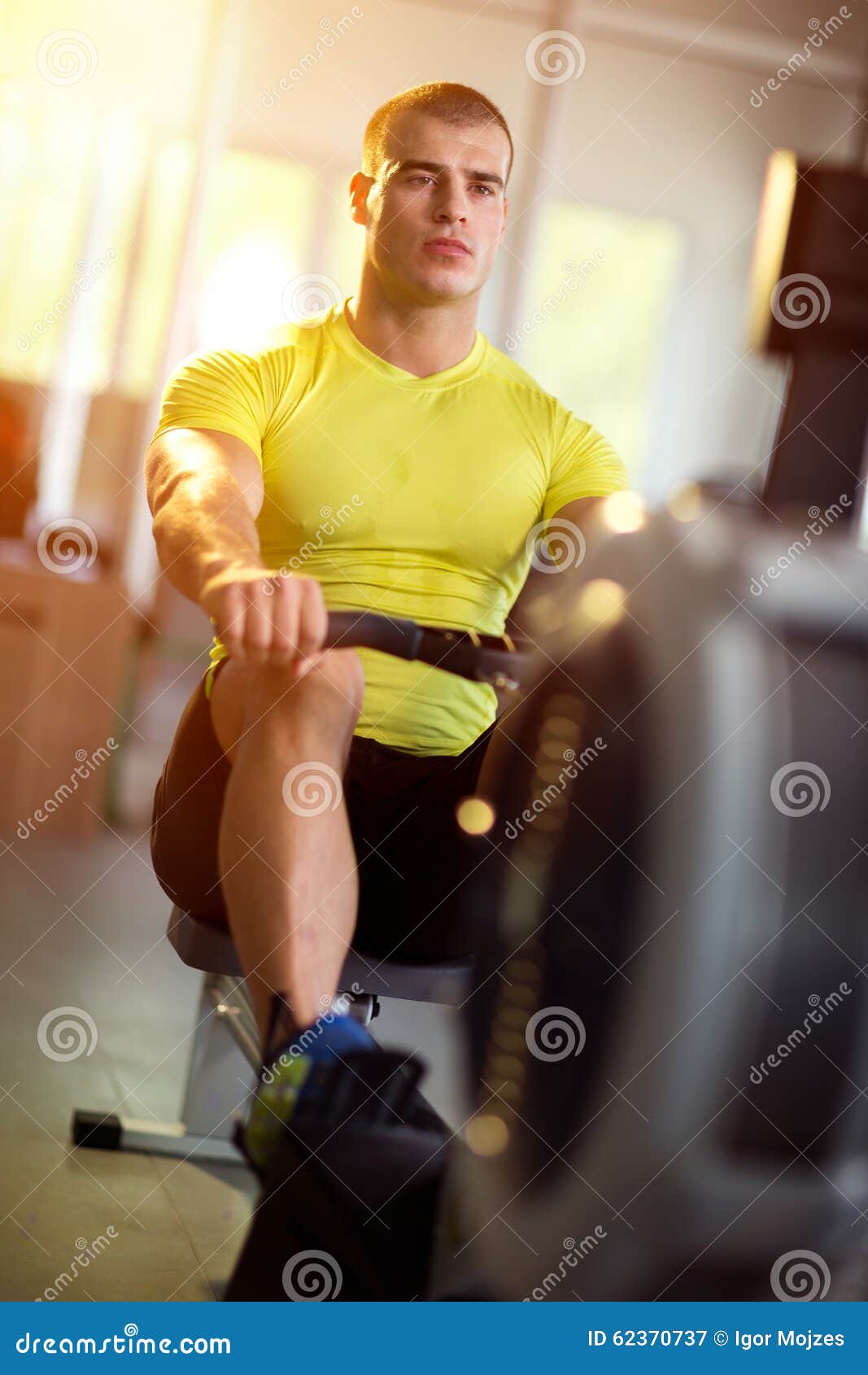 Man Working Out on Row Machine in Fitness Studio Stock Image - Image of ...
