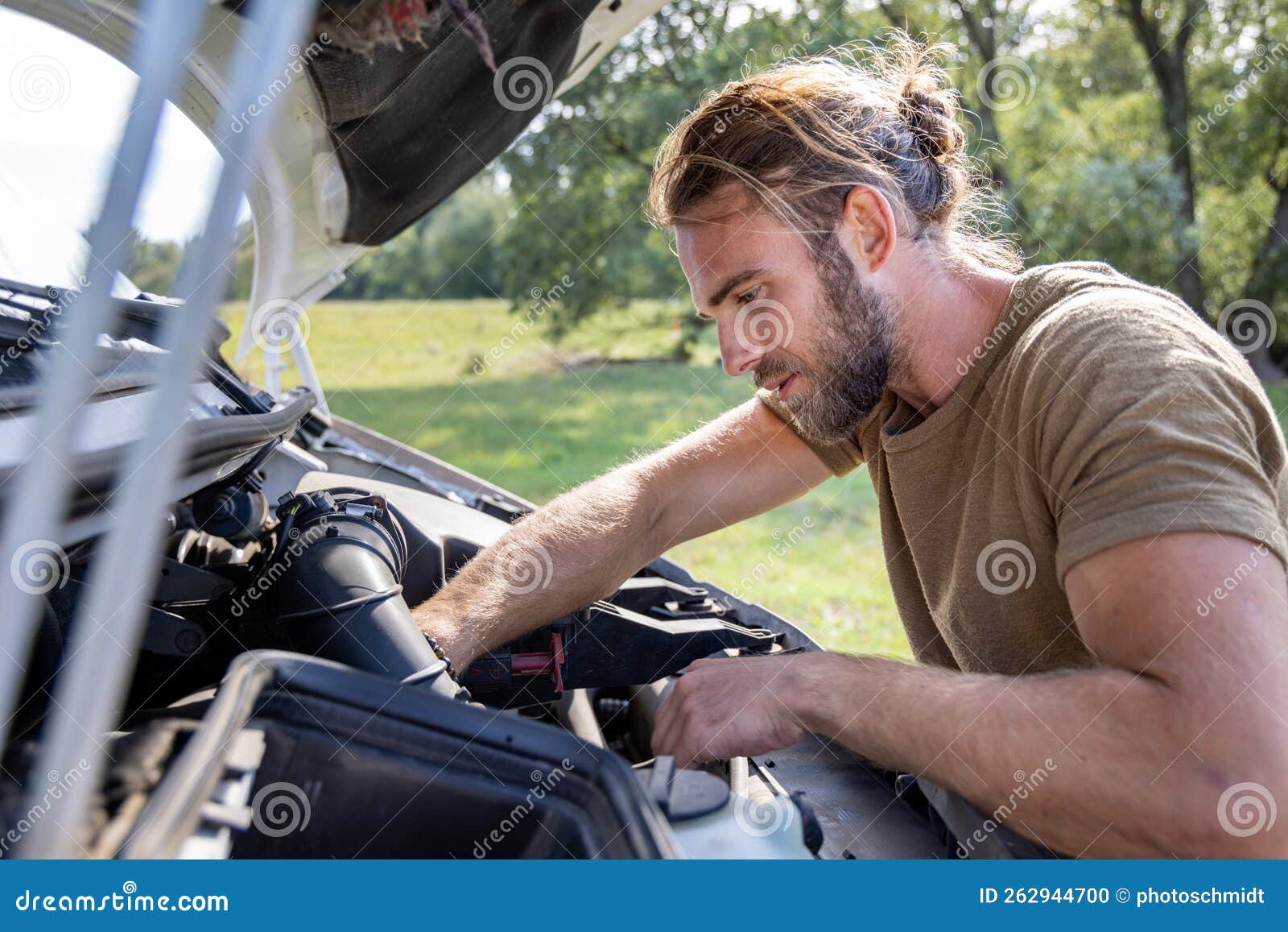 Man Working Outdoors on the Engine Compartment of a Van Stock Photo ...