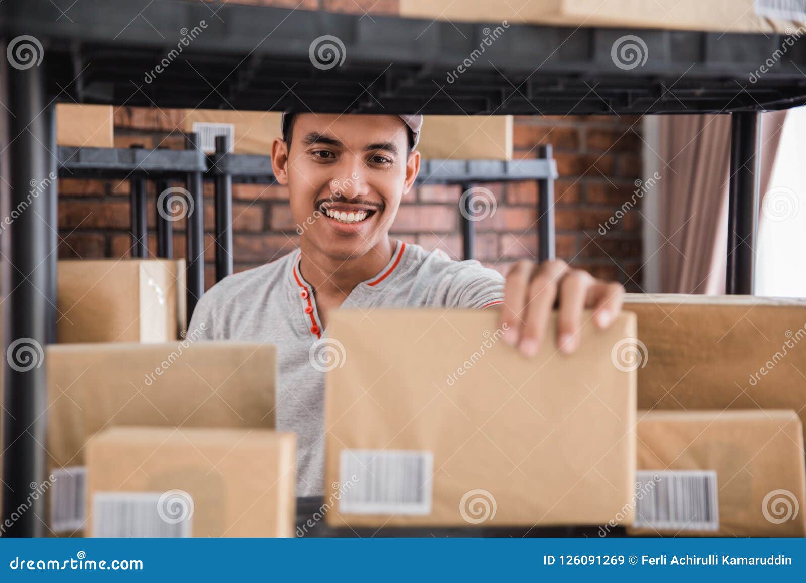 Man Working in Packages Shelf Stock Image - Image of package ...