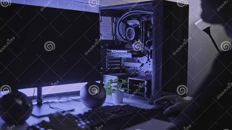 Man is Working at Professional Computer with Backlight. Clip. Man is ...