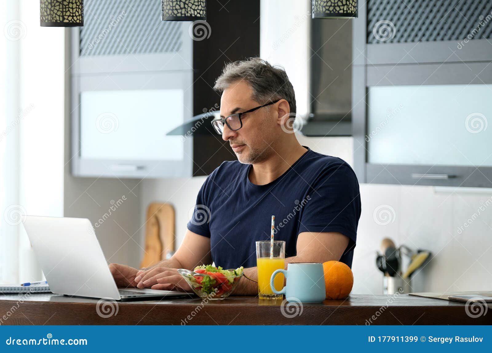 The Man is Working Remotely. Man Working Using a Laptop at Home Stock ...