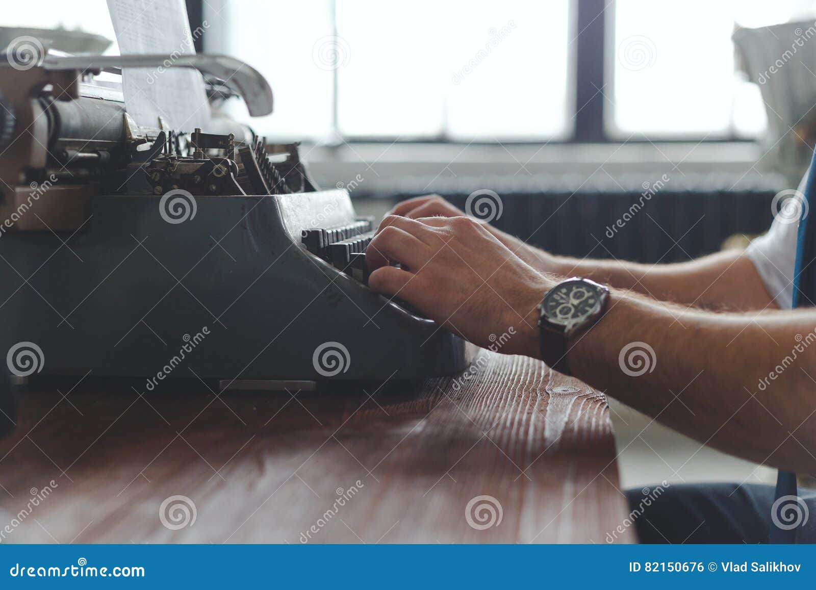 Man Working on Retro Typewriter at Desk in Parlor Room Stock Photo ...