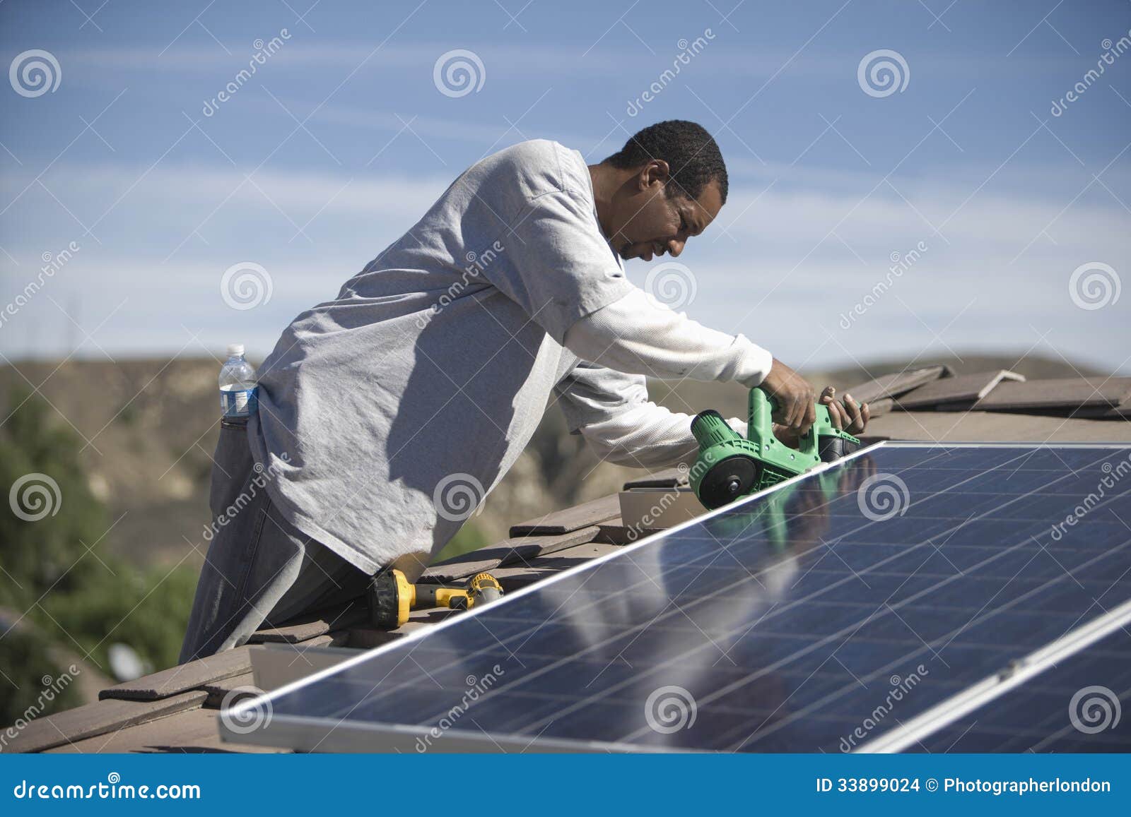 Man Working on Solar Panelling on Rooftop Stock Photo - Image of ...