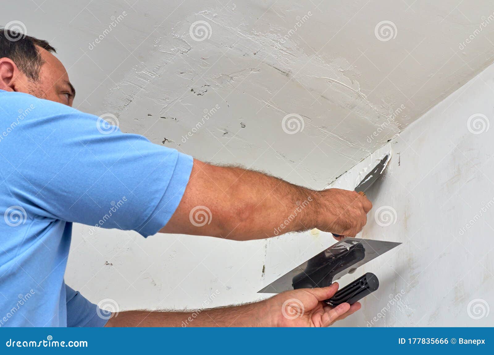 Putting spackle on a wall stock photo. Image of cement - 177835666