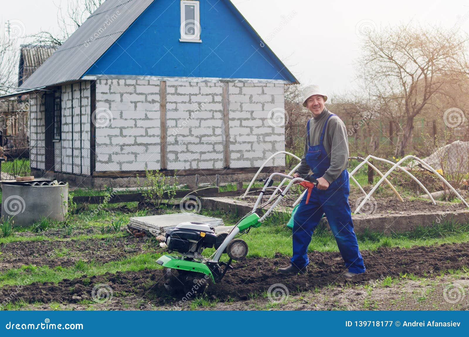 Man Working in the Spring Garden with Tiller Machine Stock Image ...