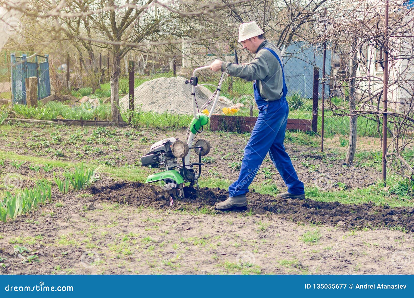 Man Working in the Spring Garden with Tiller Machine Stock Image ...