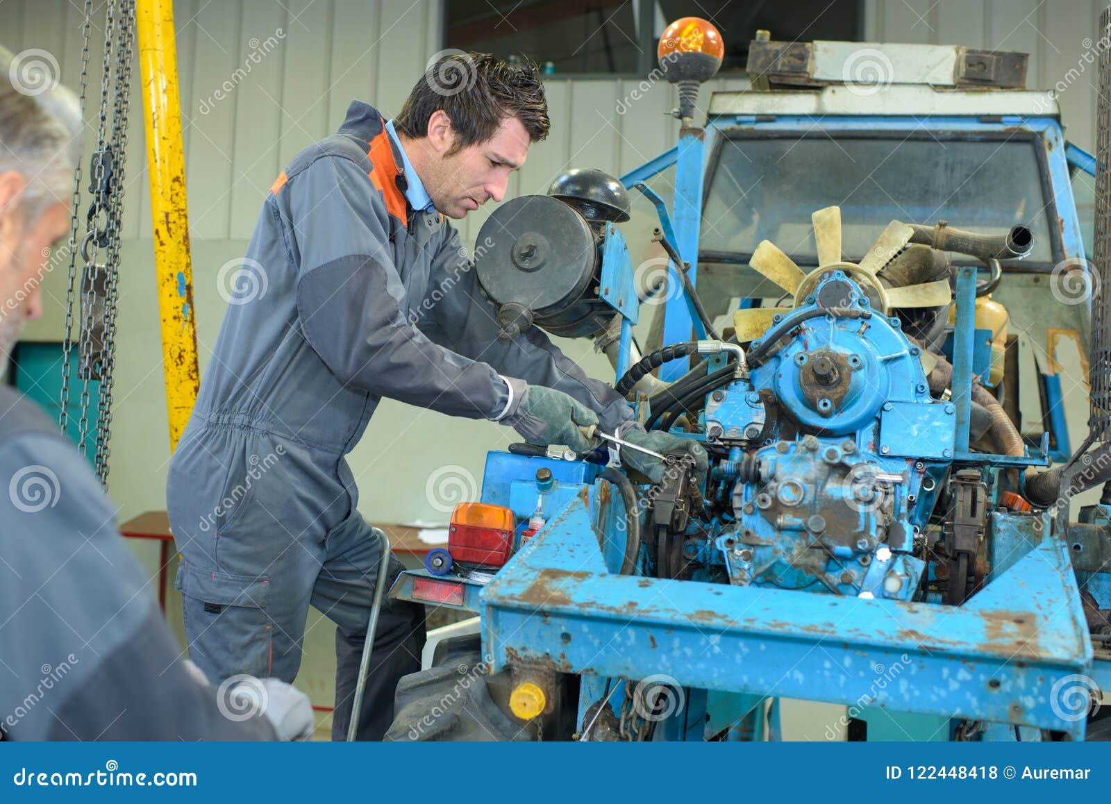 Man working on tractor stock photo. Image of broken - 122448418