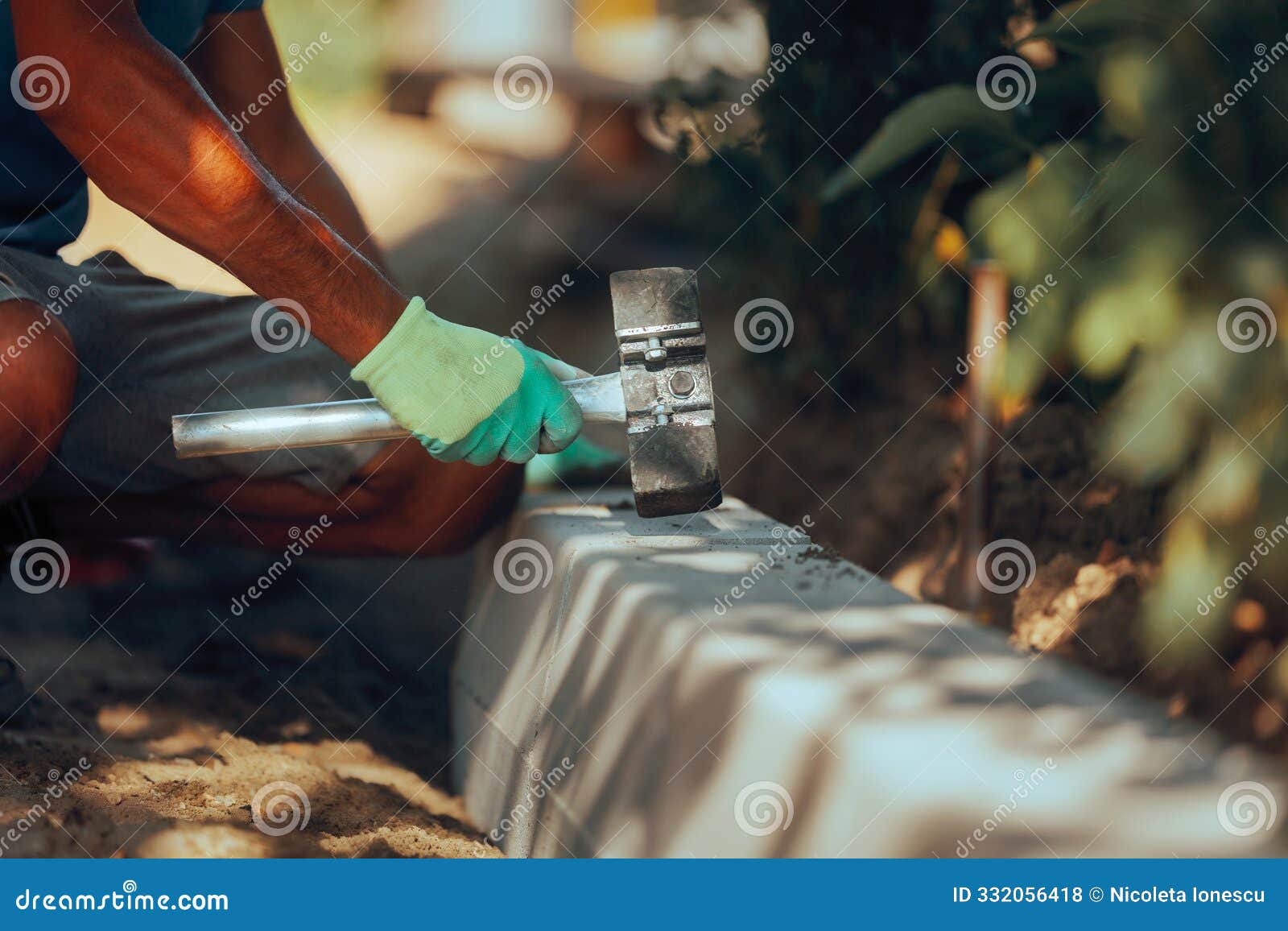 Construction Worker Using a Hammer for Fixing New Curb Blocks Stock ...