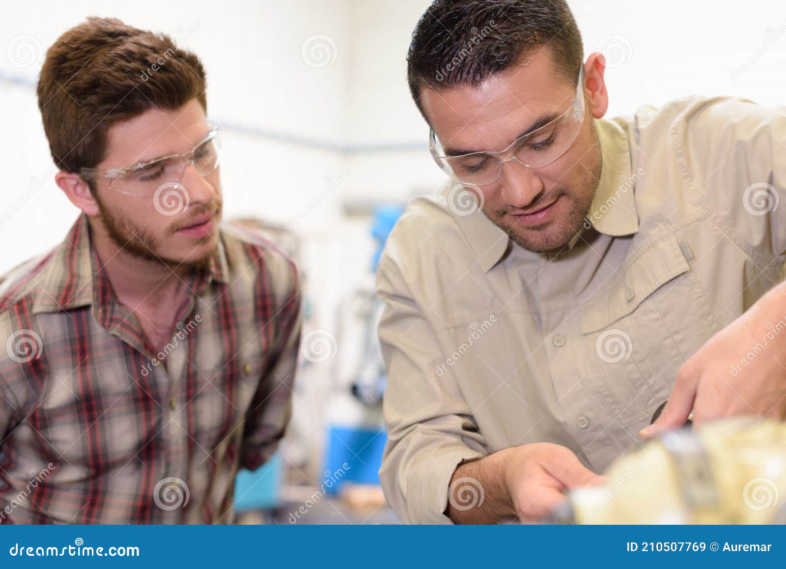 Man Working in Workshop Apprentice Watching Both Wearing Goggles Stock ...