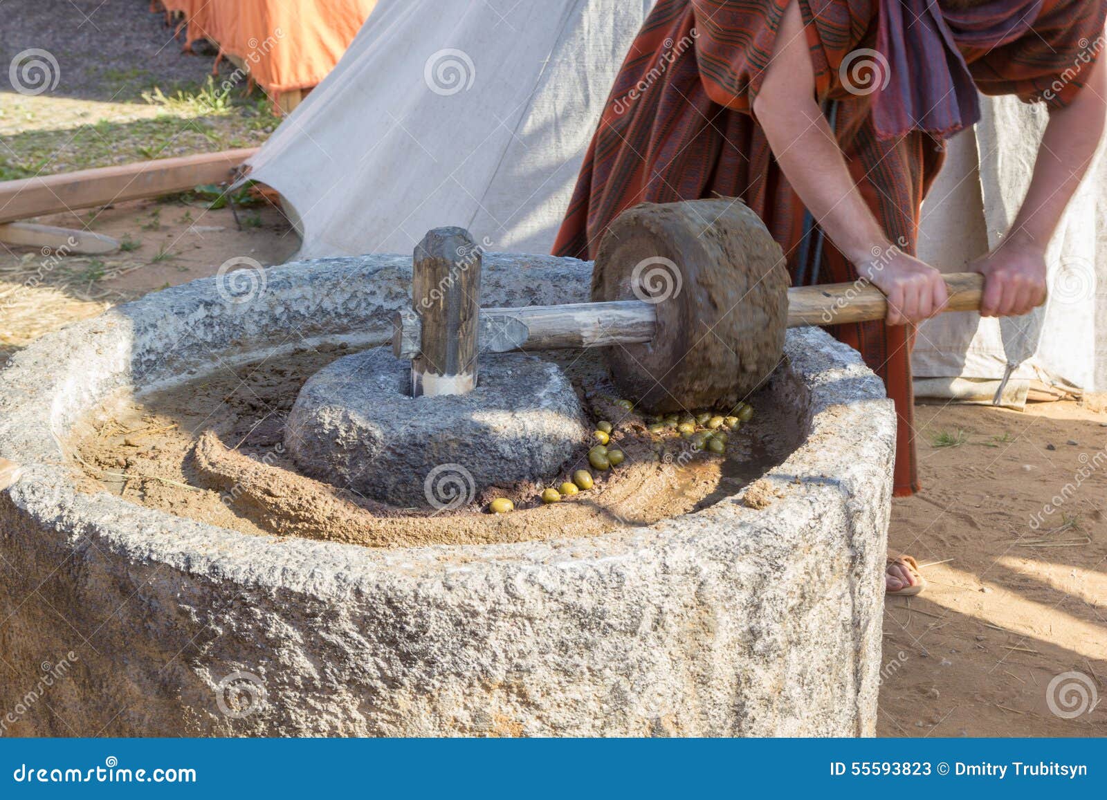 Man Works At Ancient Roman Press For Olive Oil Stock Photo - Image ...