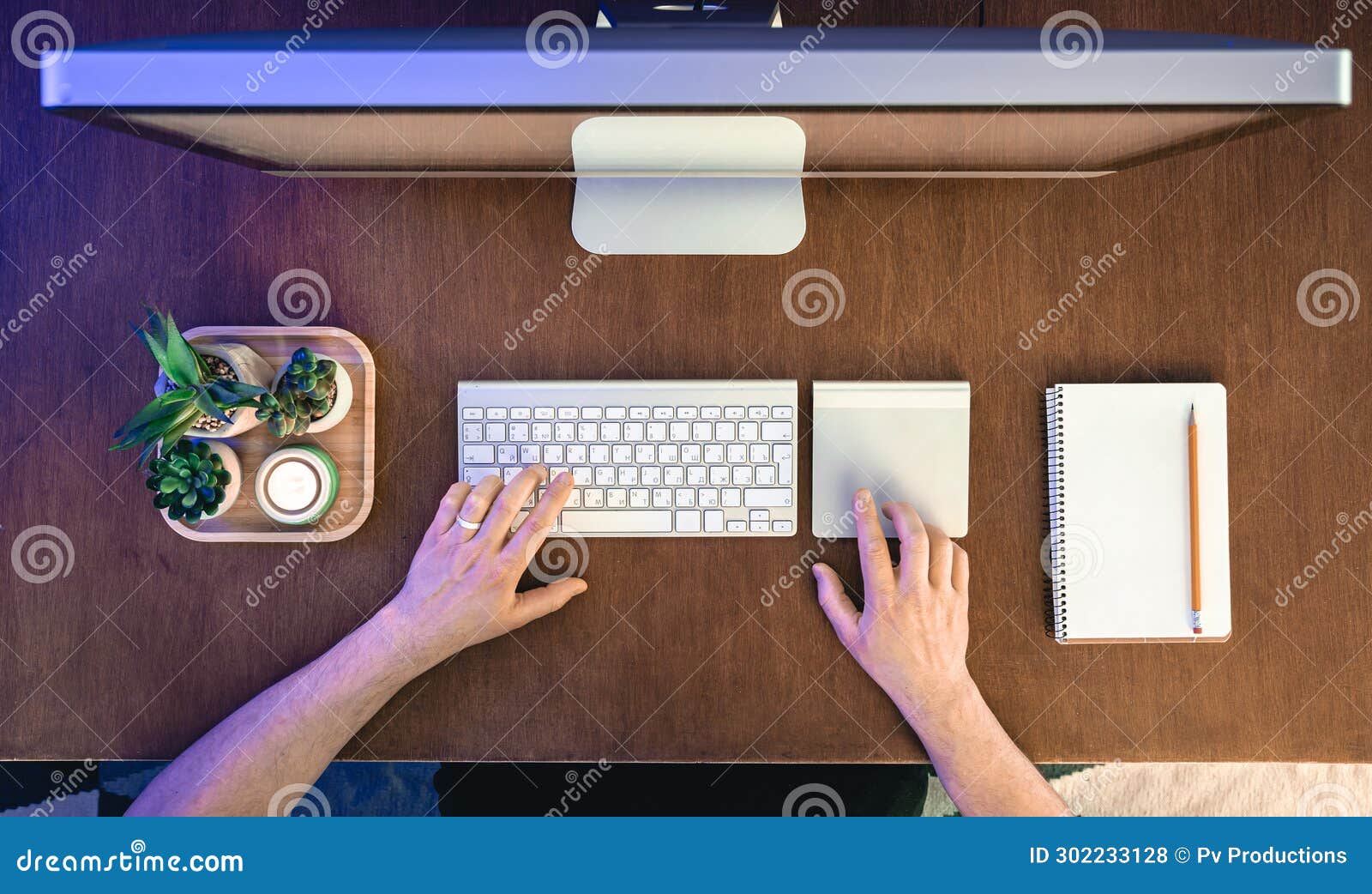 A Man Works at a Computer, Top View. Desktop Computer on a Wooden Table ...