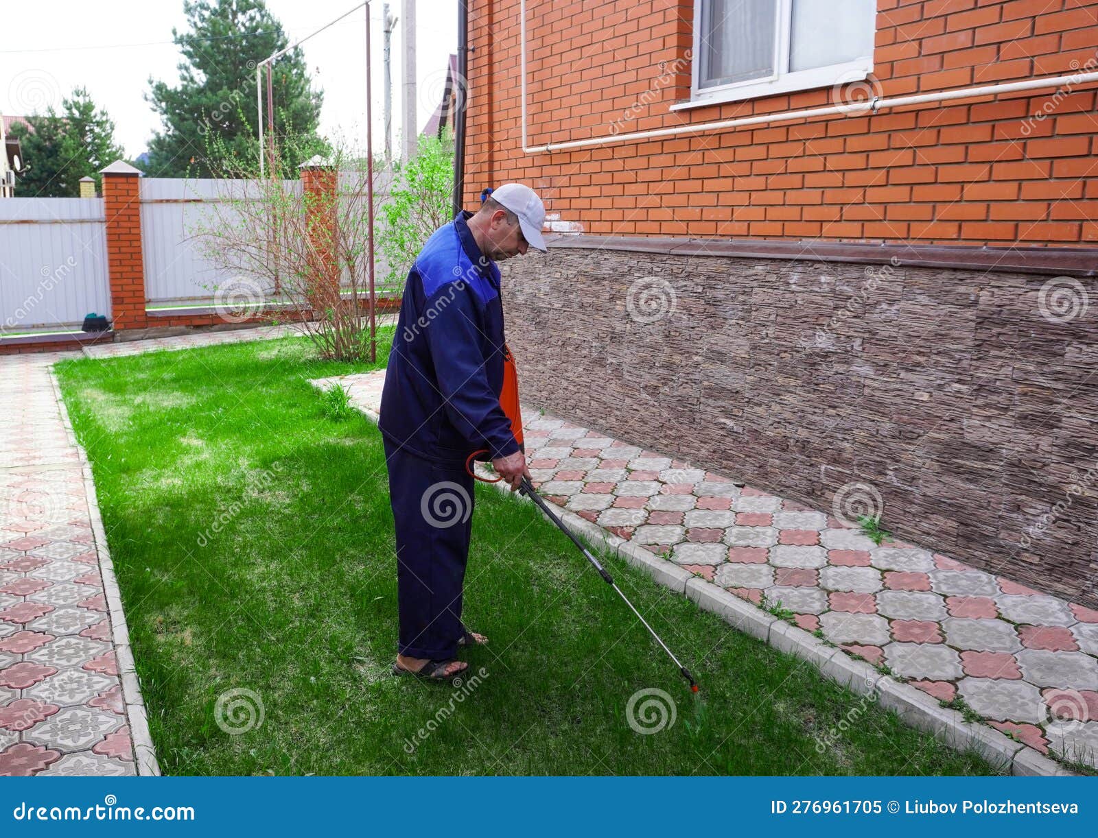 A Man Works in the Garden, Spraying Weeds from a Sprayer Stock Image ...