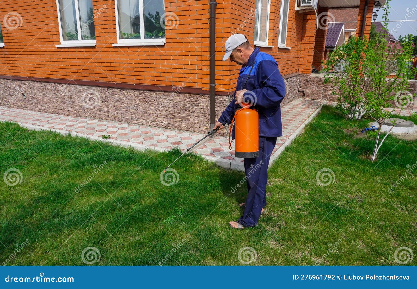 A Man Works in the Garden, Spraying Weeds from a Sprayer Stock Photo ...