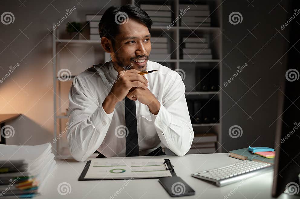 A Man Works Overtime in a Startup Company Office in the Middle of the ... A Man Works Overtime in a Startup Company Office in the Middle of the ...