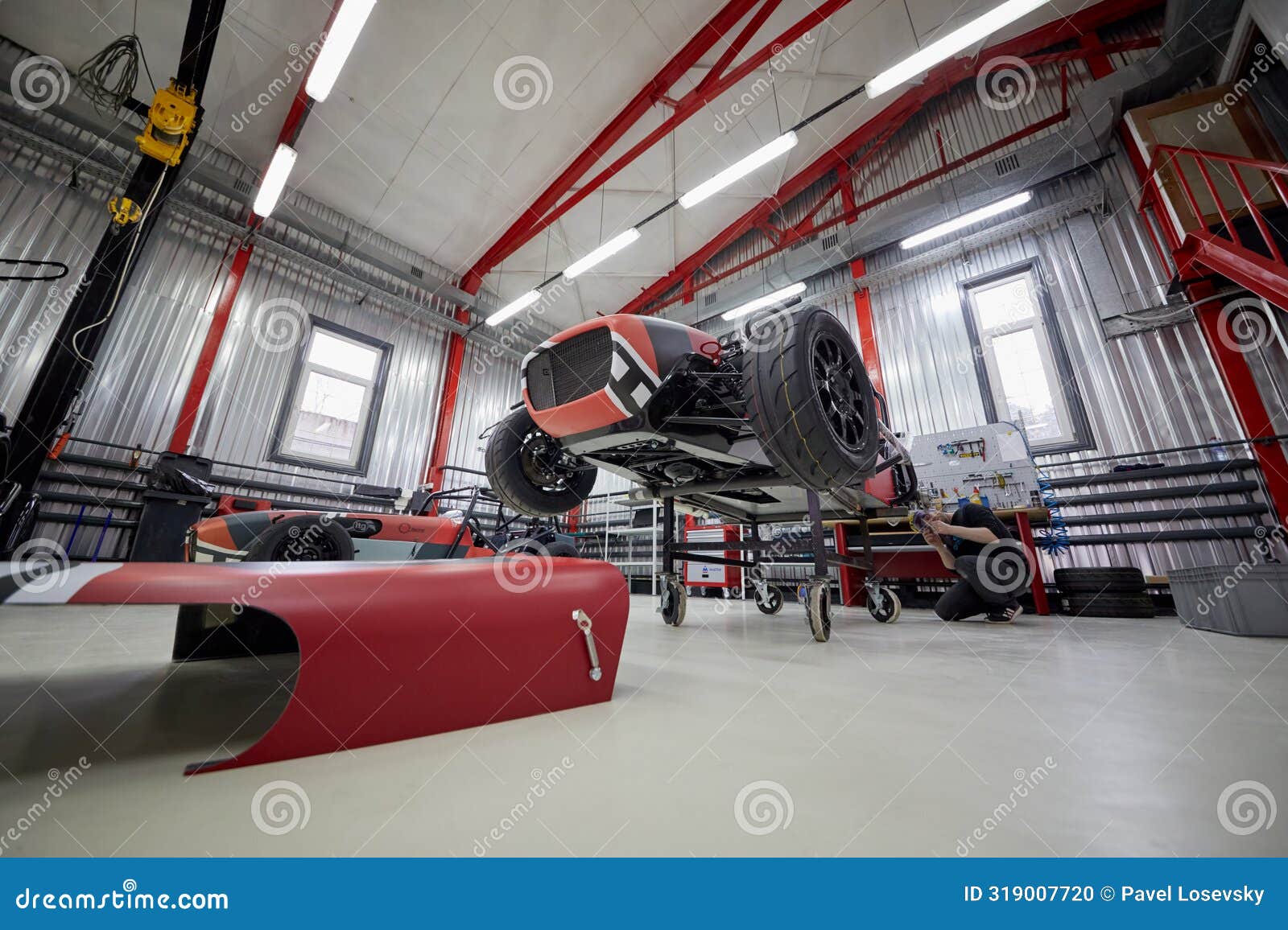 Man Works with Racing Car on Wheeled Rack Stock Photo - Image of rack ...