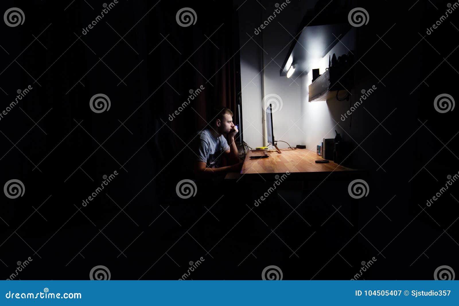 Man Works, Resting at Night at the Computer in the Room at Home, in the ...