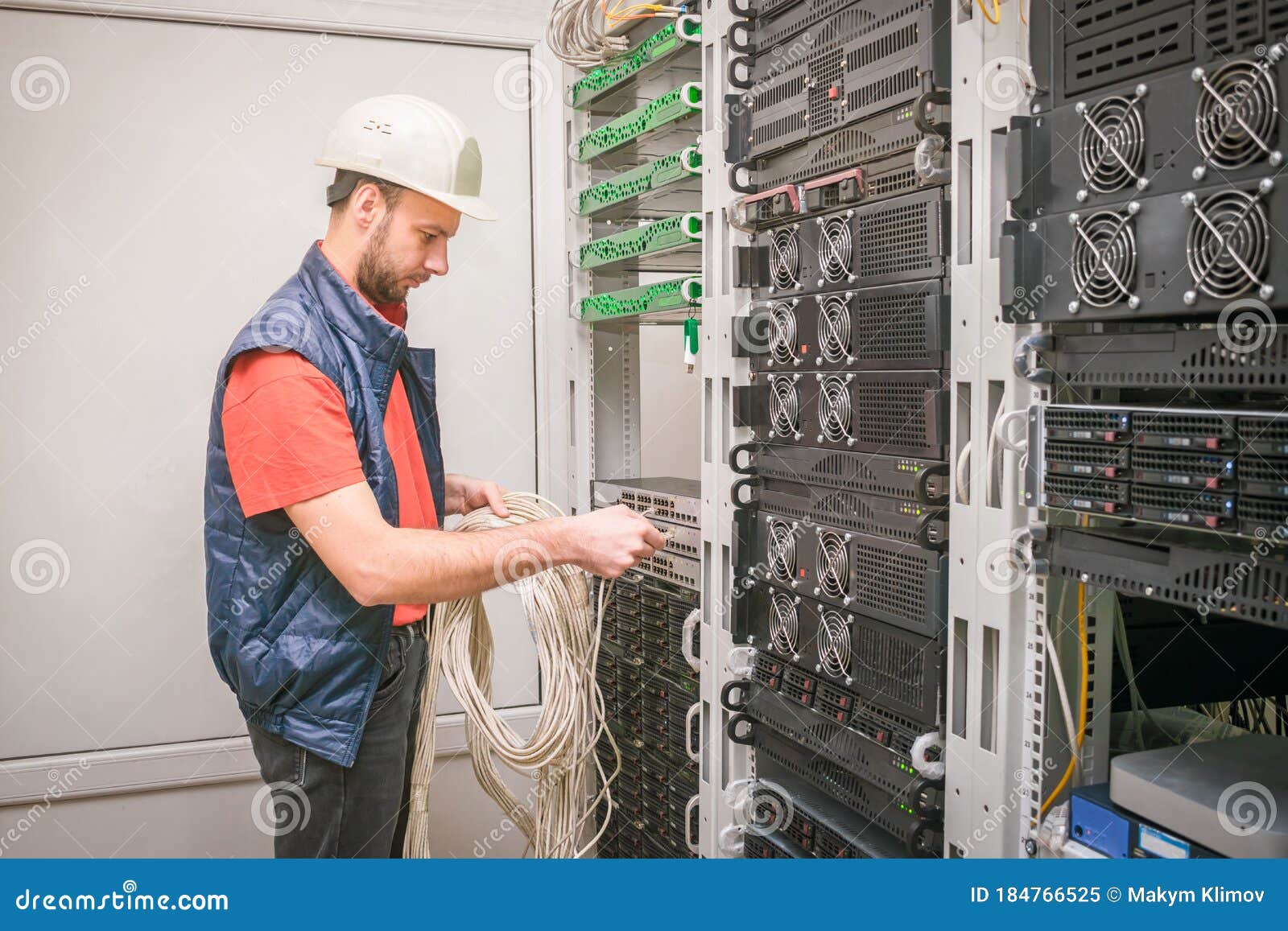 The Technician Connects The Wires To The Patch Panel Of The Server Room ...