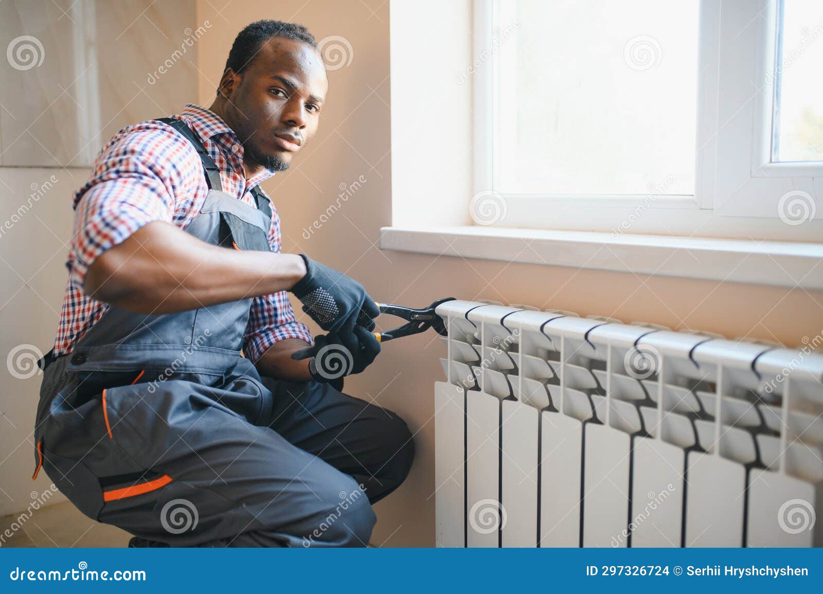 Man in Workwear Overalls Using Tools while Installing or Repairing ...