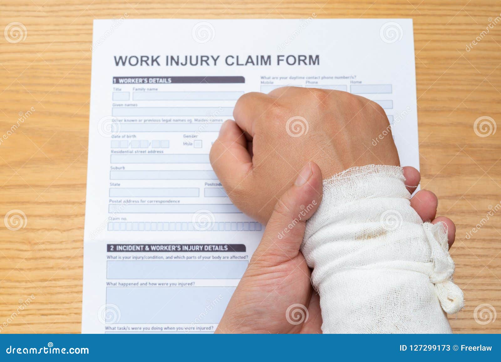 Man with Wrapped Hand on Top of Work Injury Claim Form Stock Image ...