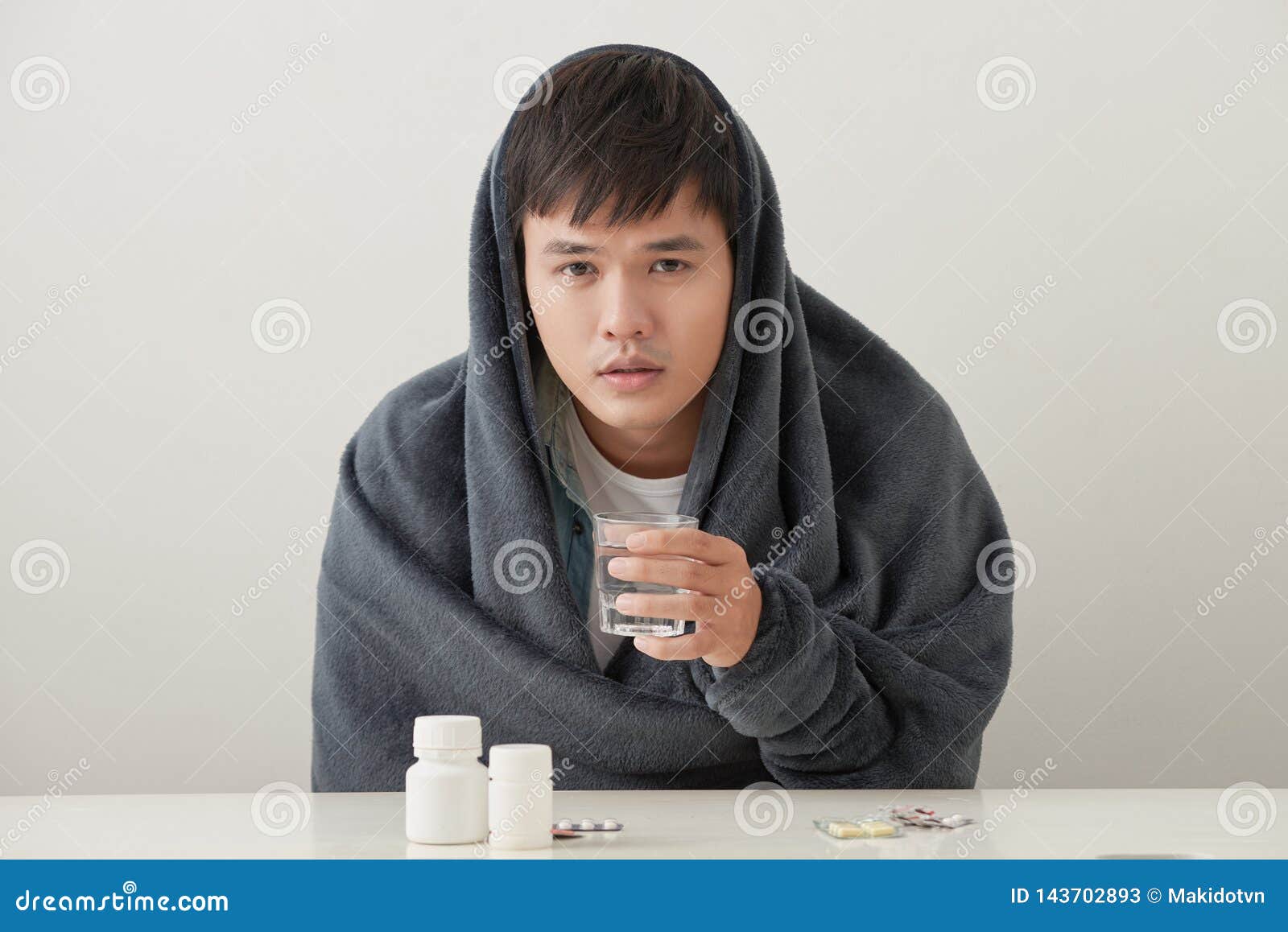 A Man Wrapped in a Warm Blanket Basks on a Light Background Stock Image ...