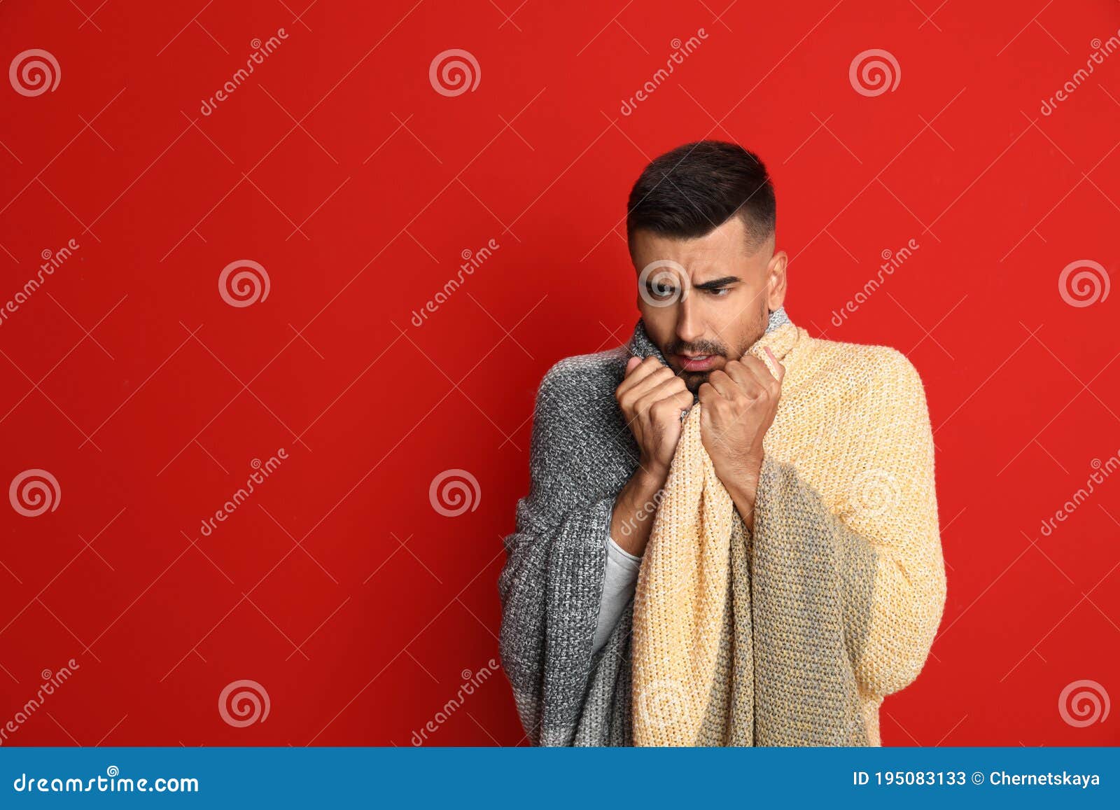 Man Wrapped in Warm Blanket Suffering from Cold on Background, Space ...