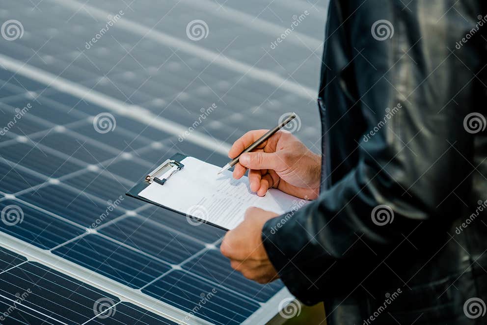 Man Write Notes on Clipboard beside Solar Battery Stock Photo - Image ...