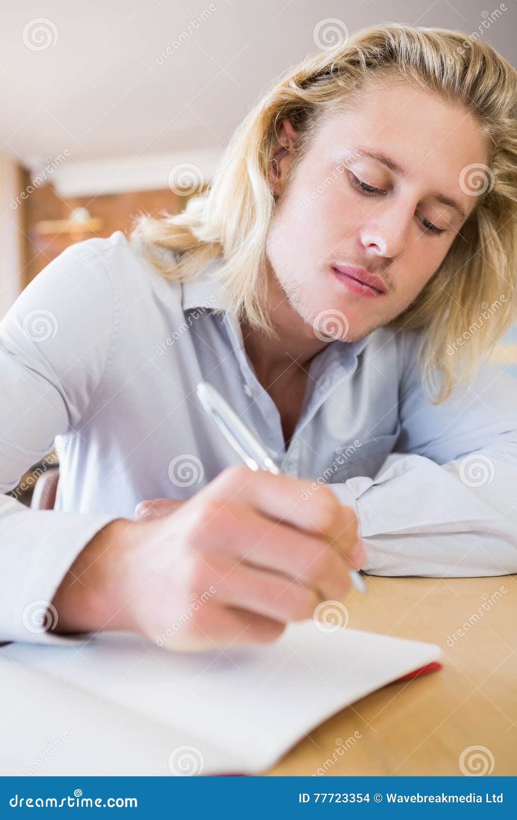 Man writing on a book stock photo. Image of indoors, young - 77723354