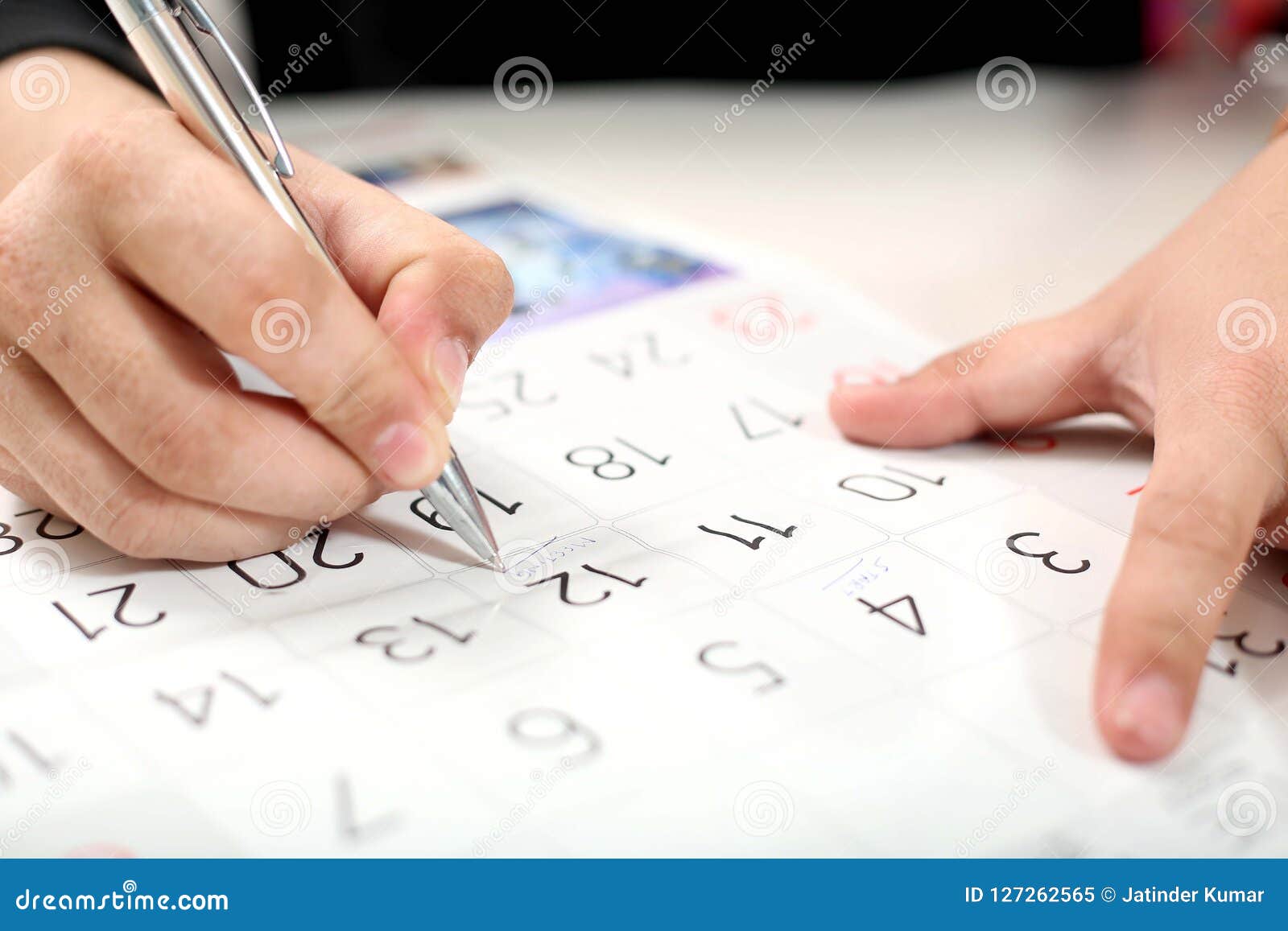 Man is writing on calendar stock image. Image of blue - 127262565