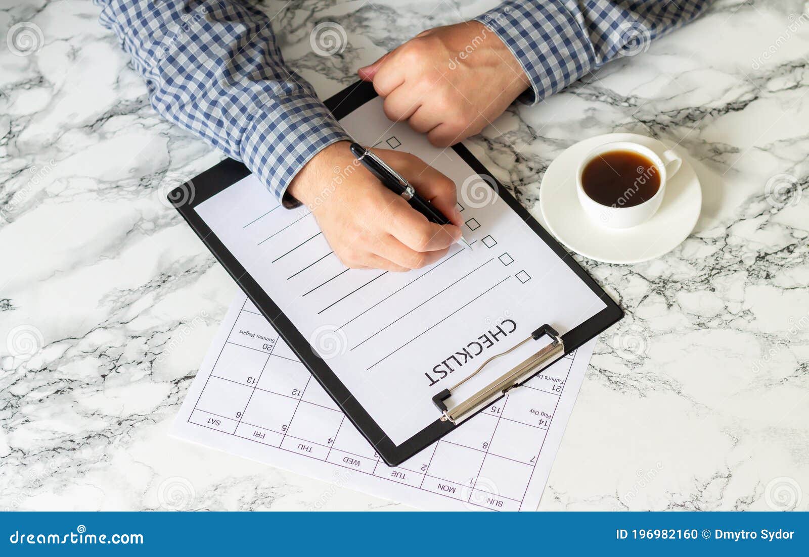 Man Writing Checklist Next To Cup of Coffee on Office Table Top View ...
