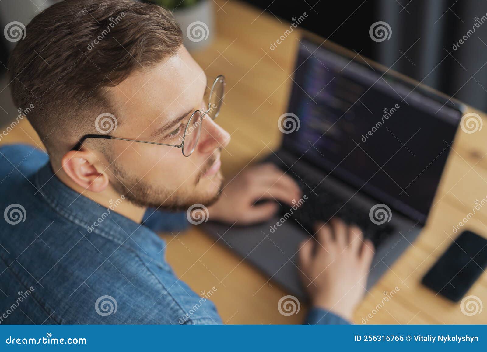 Man writing code on laptop stock photo. Image of meeting - 256316766