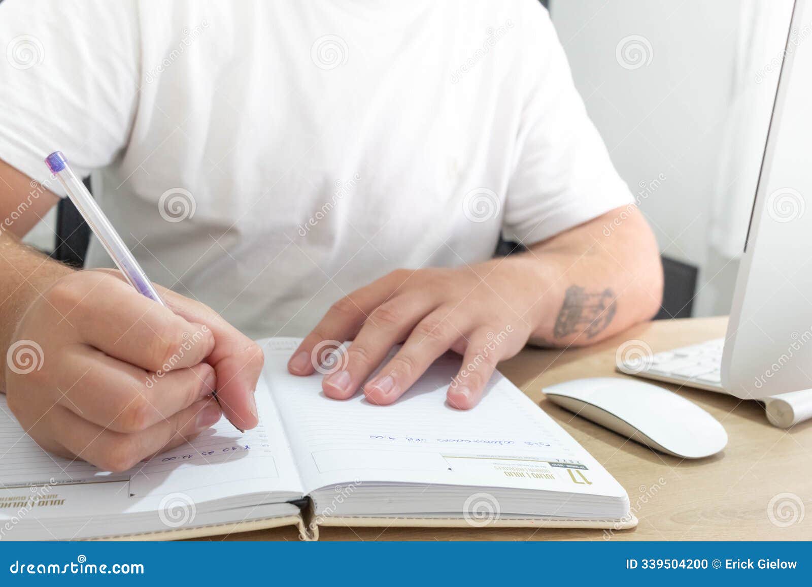 Man Writing Down Information in Notebook during Work Stock Photo ...
