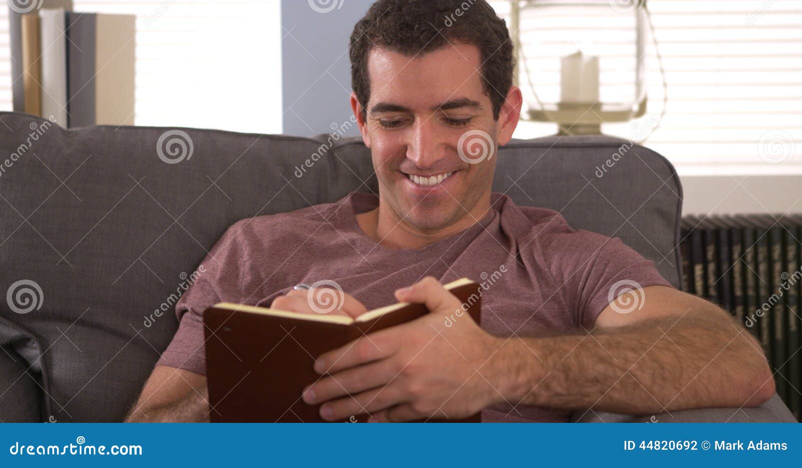 Man Writing Down Notes in Book Stock Photo - Image of notebook, couch ...