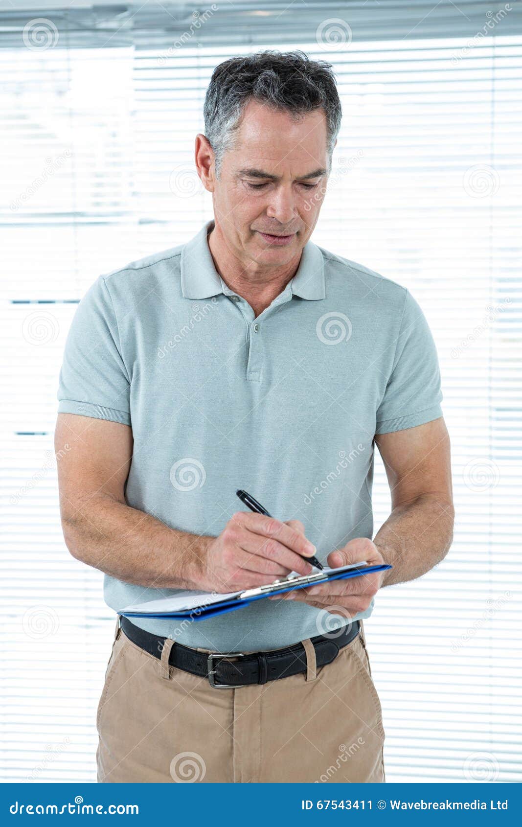 Man Writing Down Notes in Office Stock Image - Image of male, workplace ...