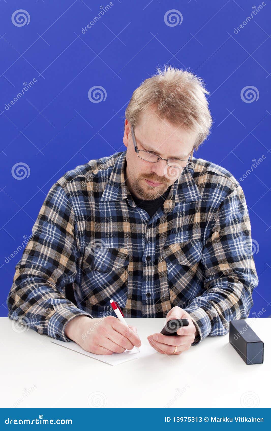 Man writing at his desk stock image. Image of serious - 13975313