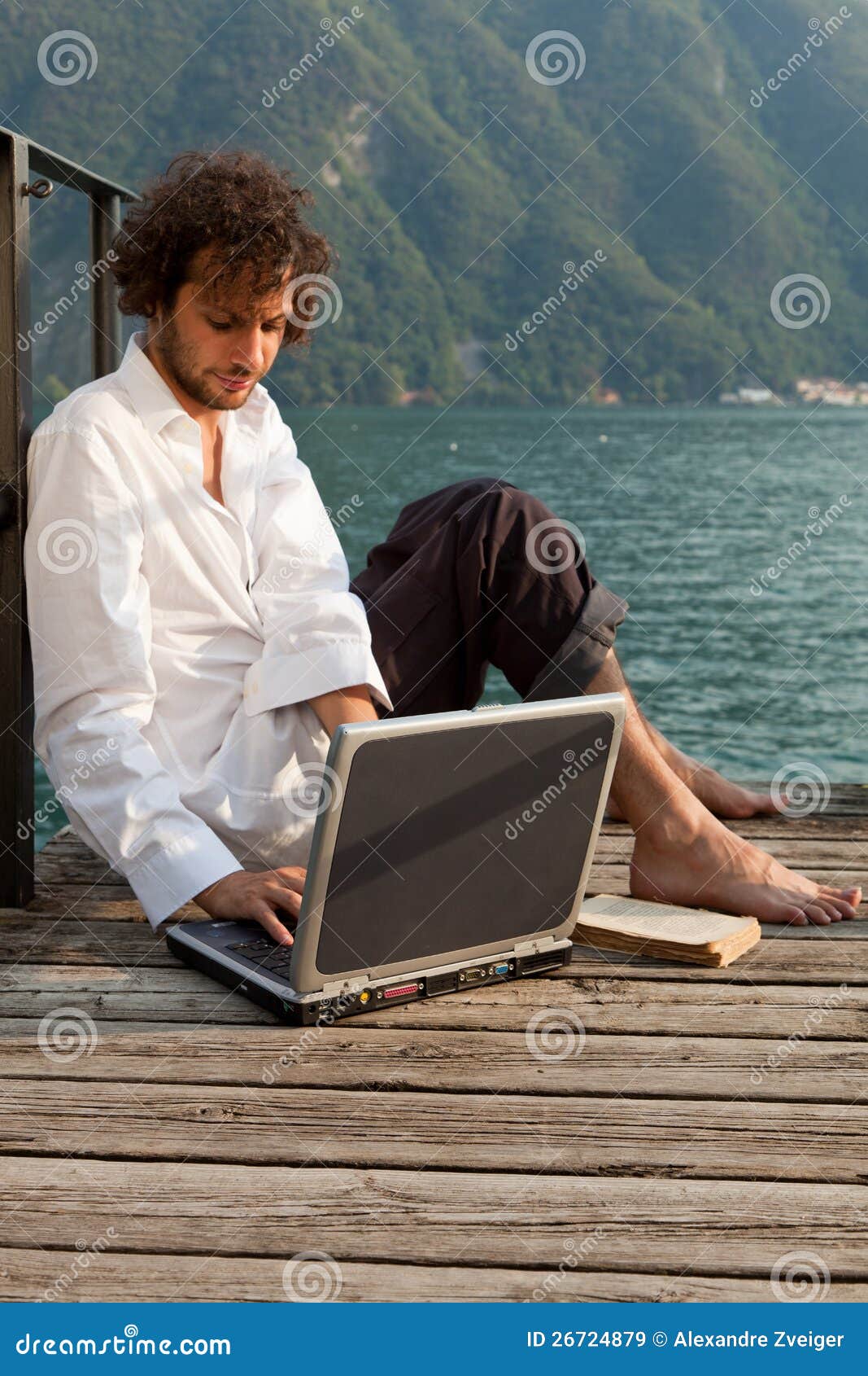 Man writing on the laptop stock image. Image of mountain - 26724879