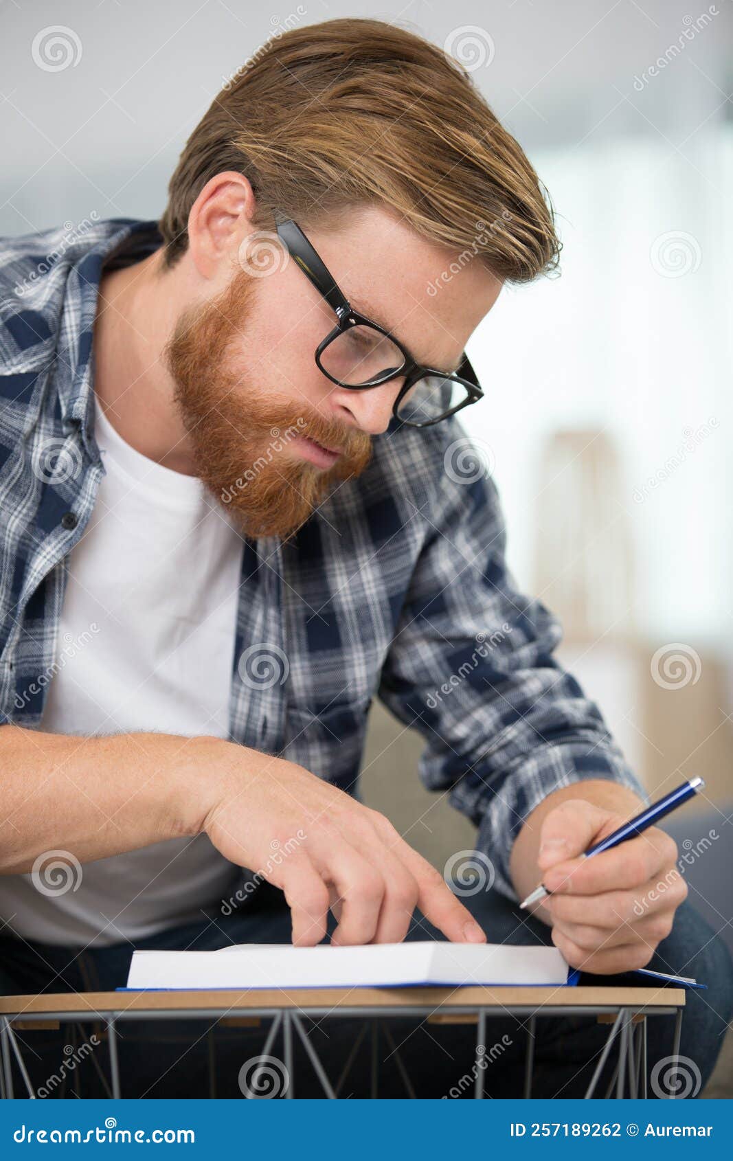 Man writing note on book stock photo. Image of information - 257189262