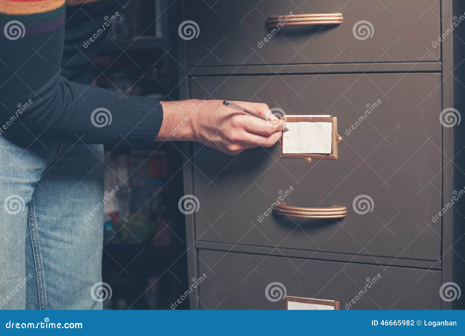 Man Writing Note on File Cabinet Stock Photo - Image of folder, files ...