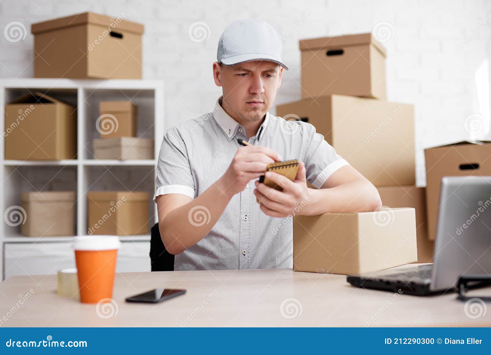 Man Writing a Note in a Notebook at the Post Office Stock Photo - Image ...