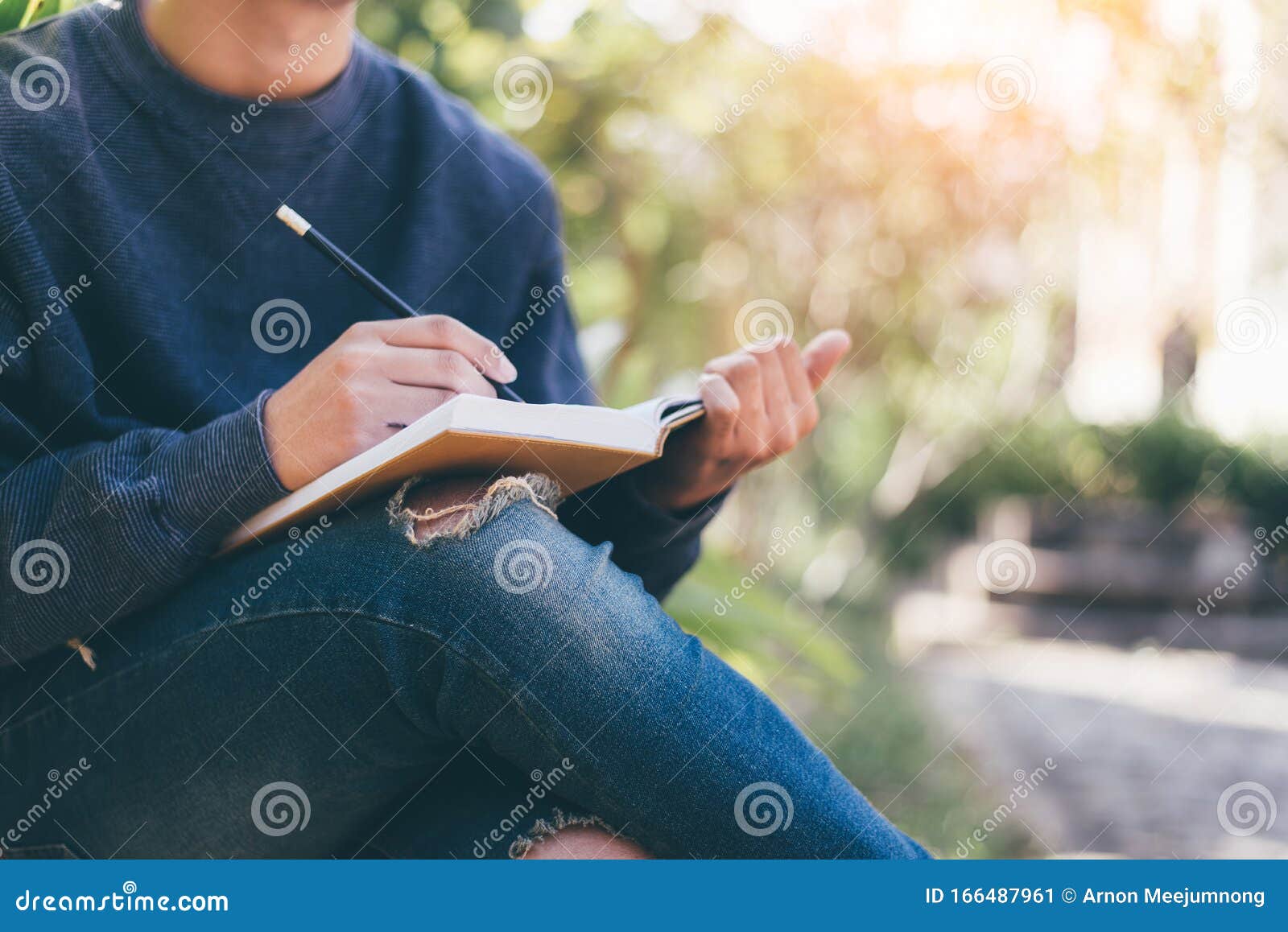 Man Writing a Note in the Park Stock Image - Image of male, jacket ...