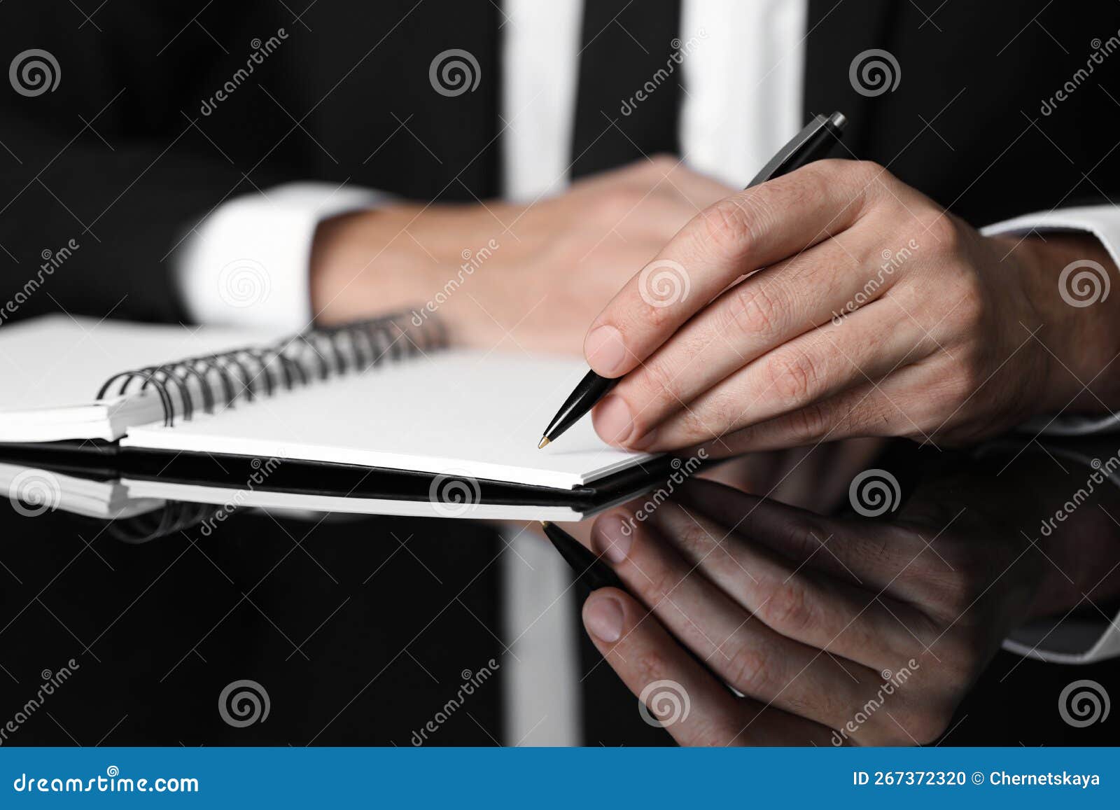 Man Writing in Notebook at Black Table, Closeup Stock Photo - Image of ...