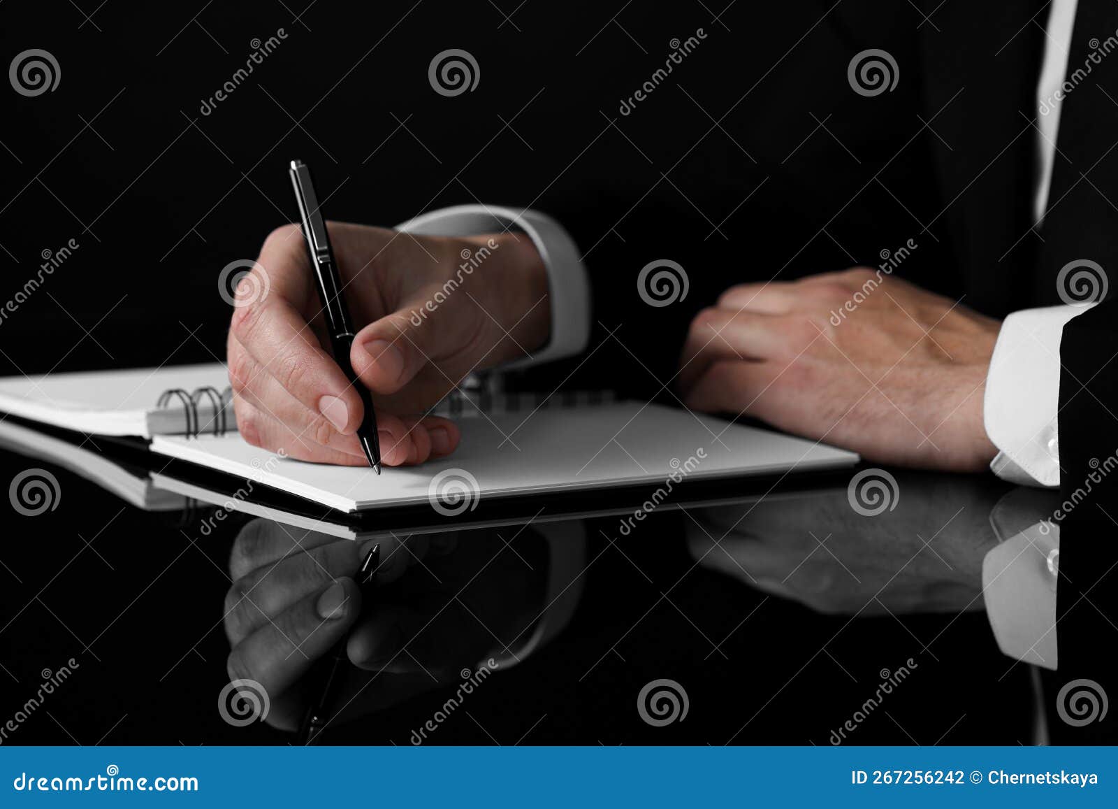 Man Writing in Notebook at Black Table, Closeup Stock Photo - Image of ...