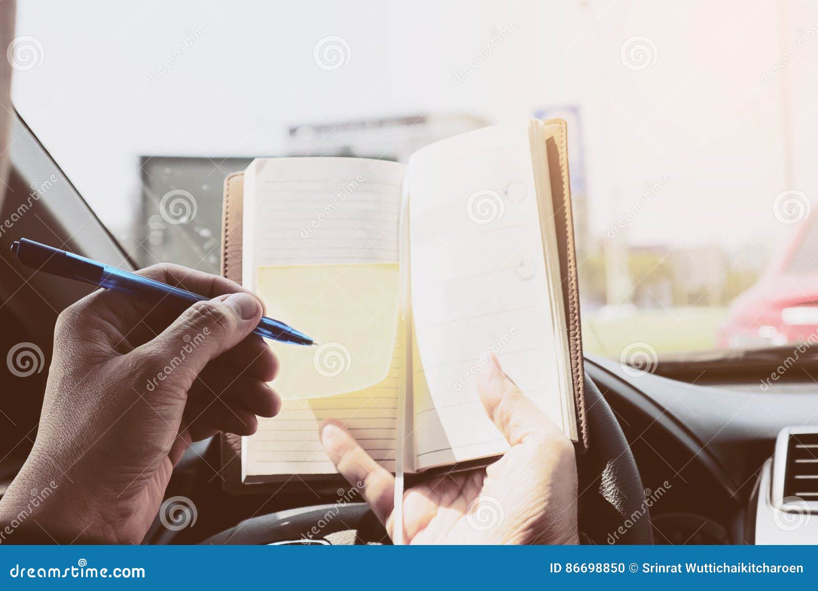 Man Writing Notebook while Driving Car Stock Photo - Image of letter ...