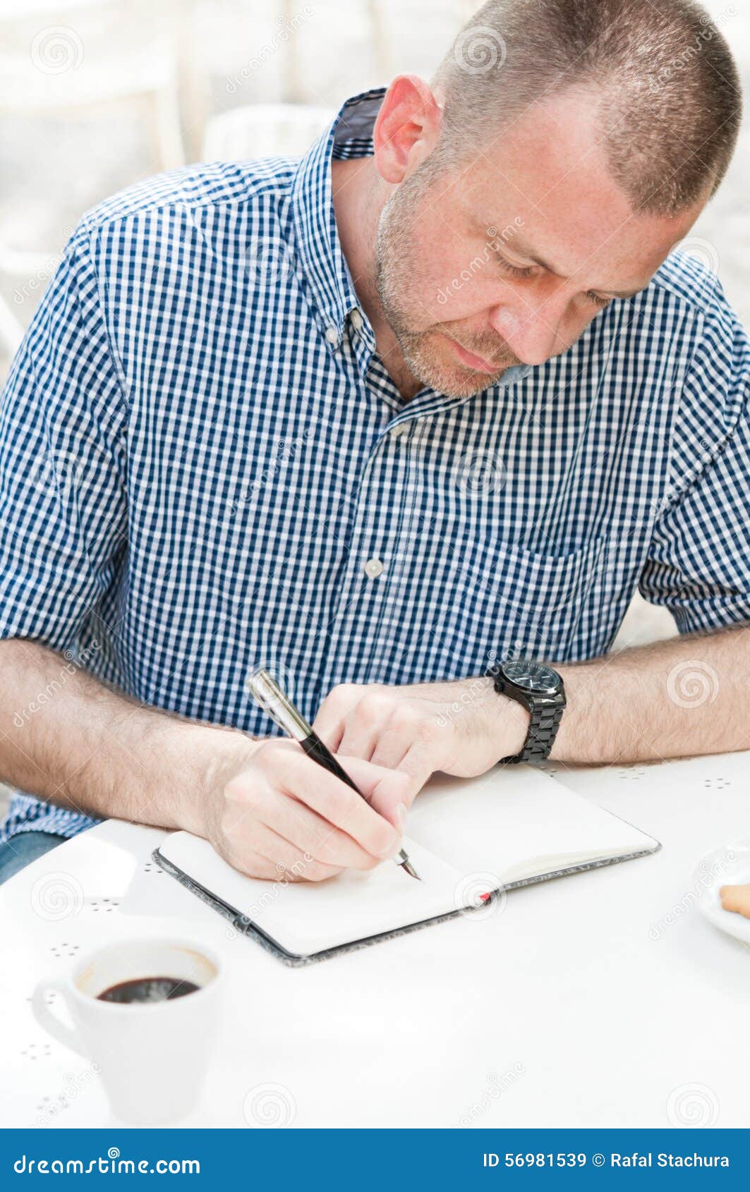 Man Writing in Notebook stock image. Image of portrait - 56981539