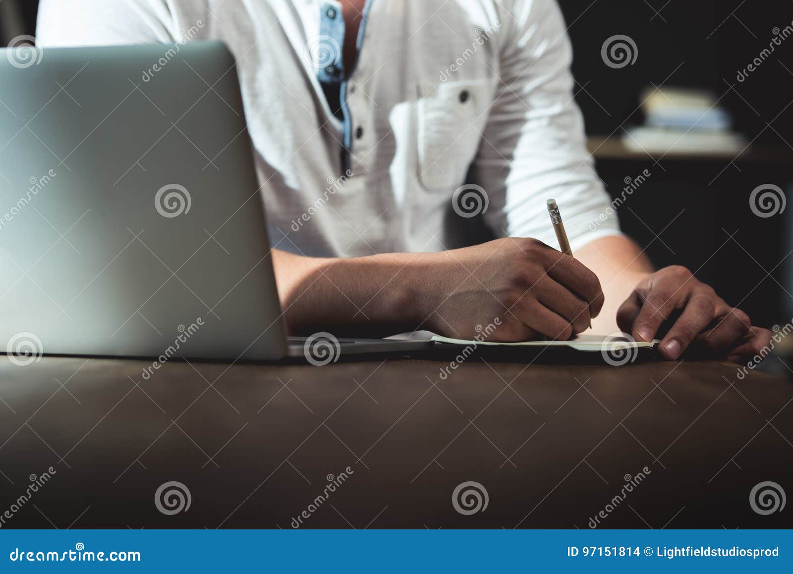 Man Writing in Notebook during Work while Sitting at the Table with ...