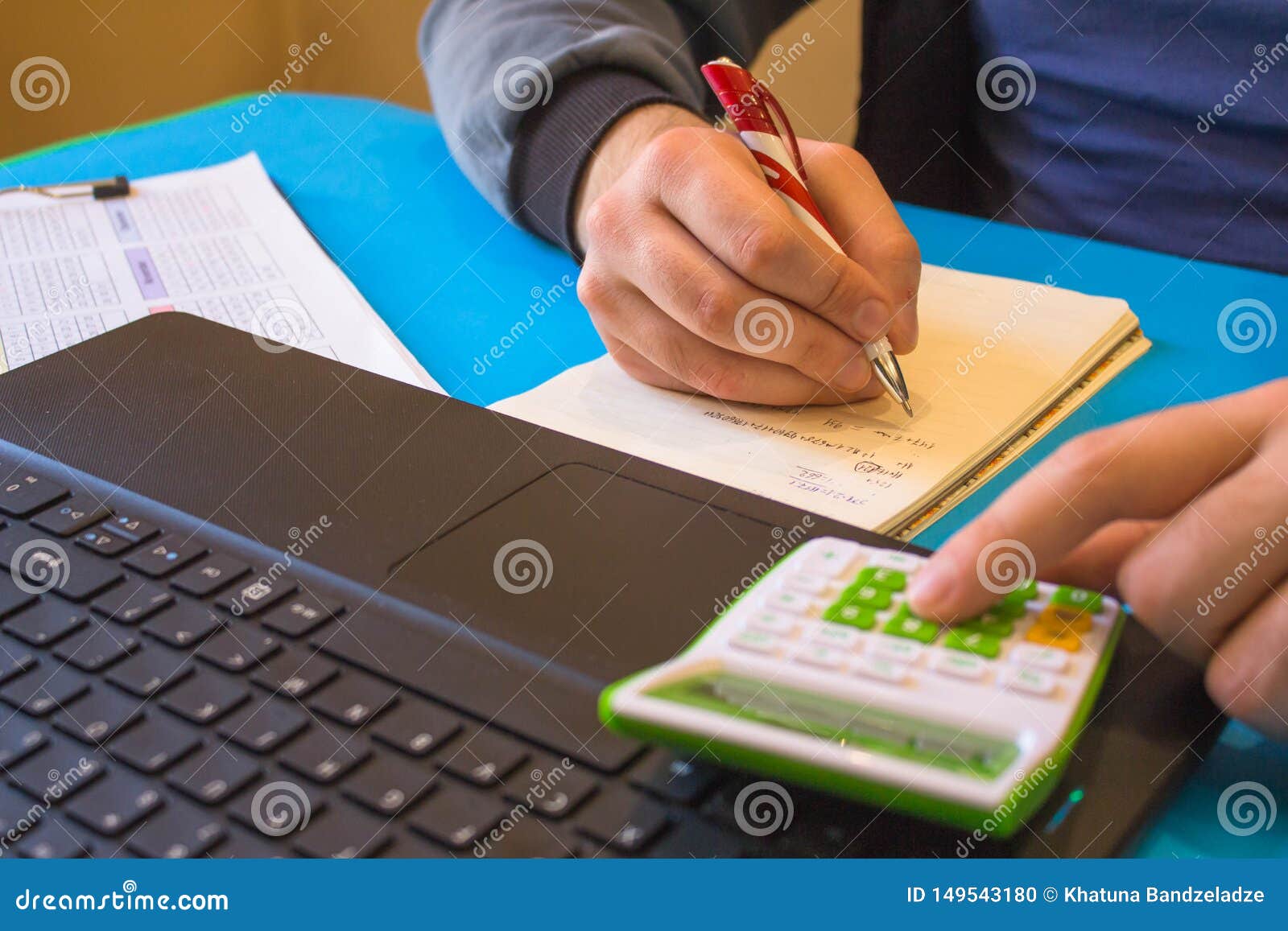 Man Writing Notes from Computer on Table. Man Hand with Pen, Calculator ...