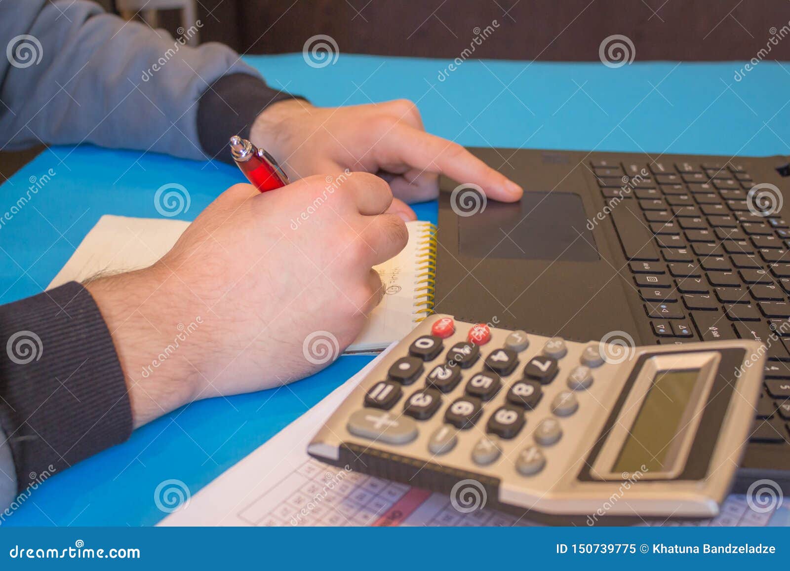 Man Writing Notes from Computer on Table. Man Hand with Pen, Calculator ...