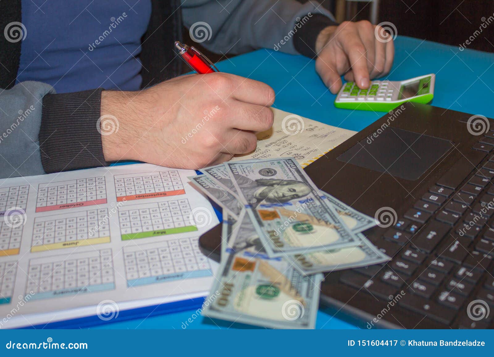 Man Writing Notes from Computer on Table. Man Hand with Pen, Calculator ...