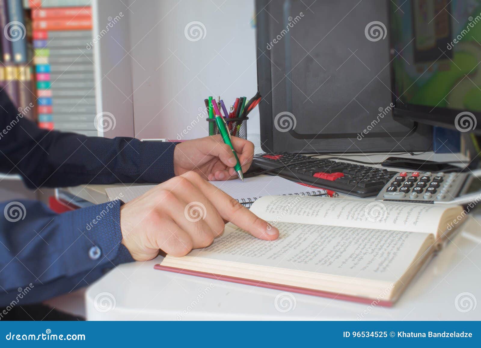 Man Writing Notes from Computer on Wooden Table. Man Hand with Pen ...