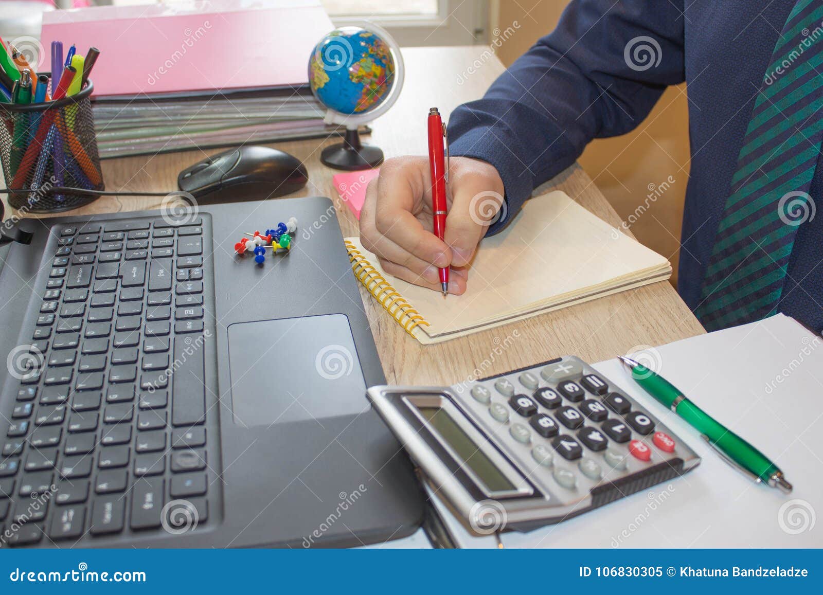Man Writing Notes from Computer on Wooden Table. Man Hand with Pen ...